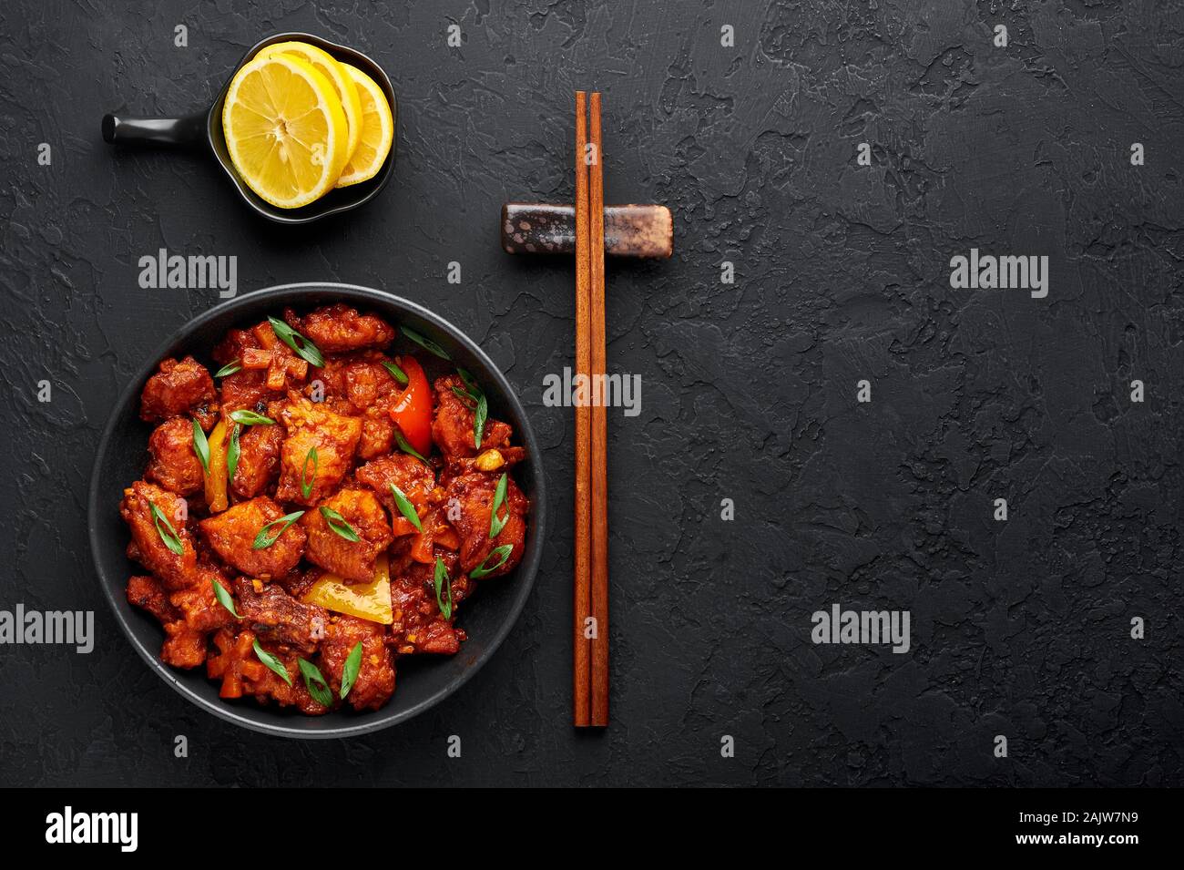 Fish Manchurian dry looks like Schezwan Fish in black bowl at dark ...