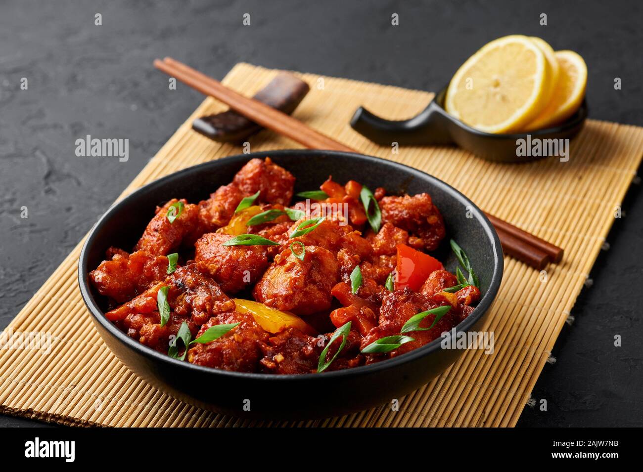 Fish Manchurian dry looks like Schezwan Fish in black bowl at dark ...