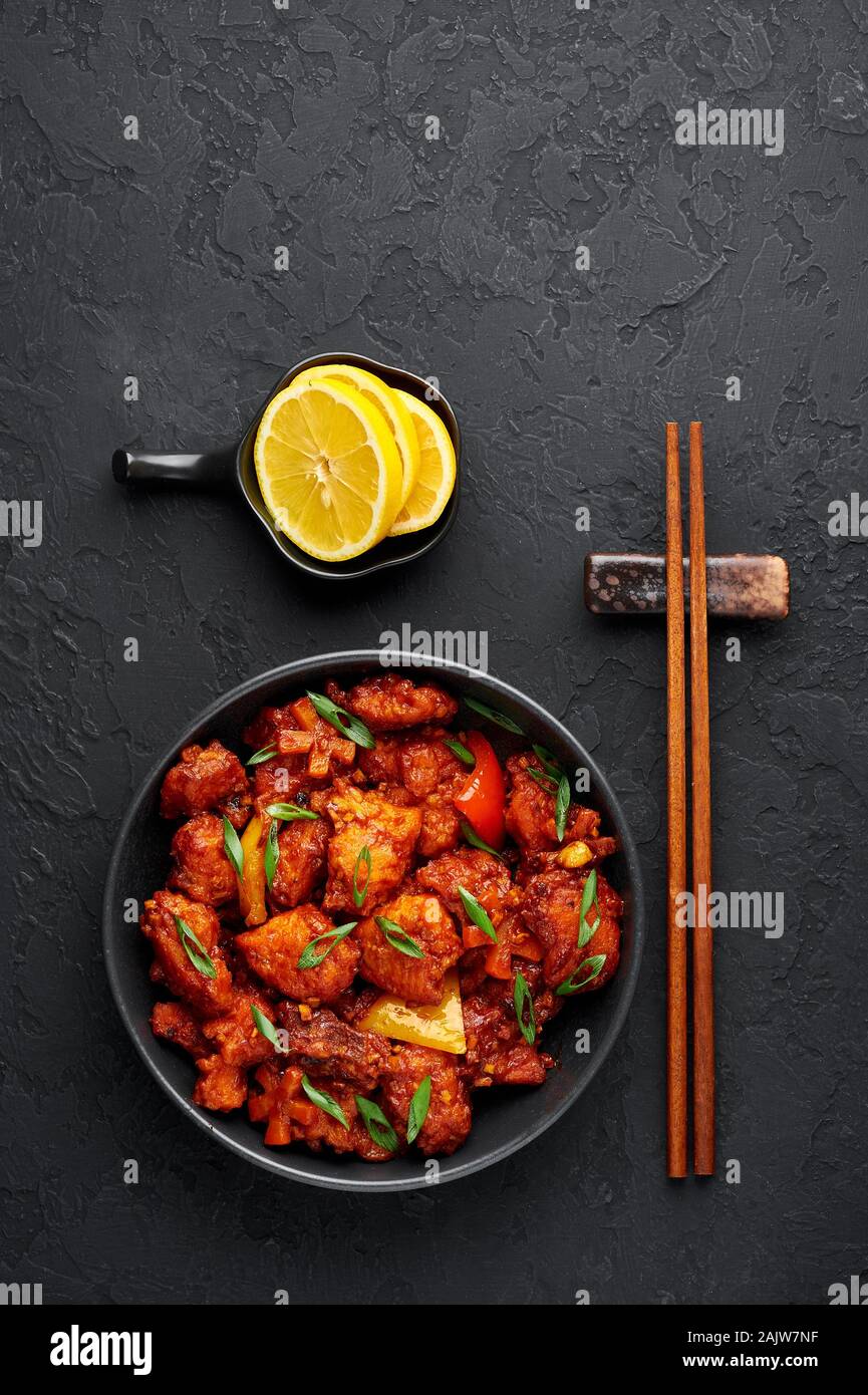 Fish Manchurian dry looks like Schezwan Fish in black bowl at dark ...