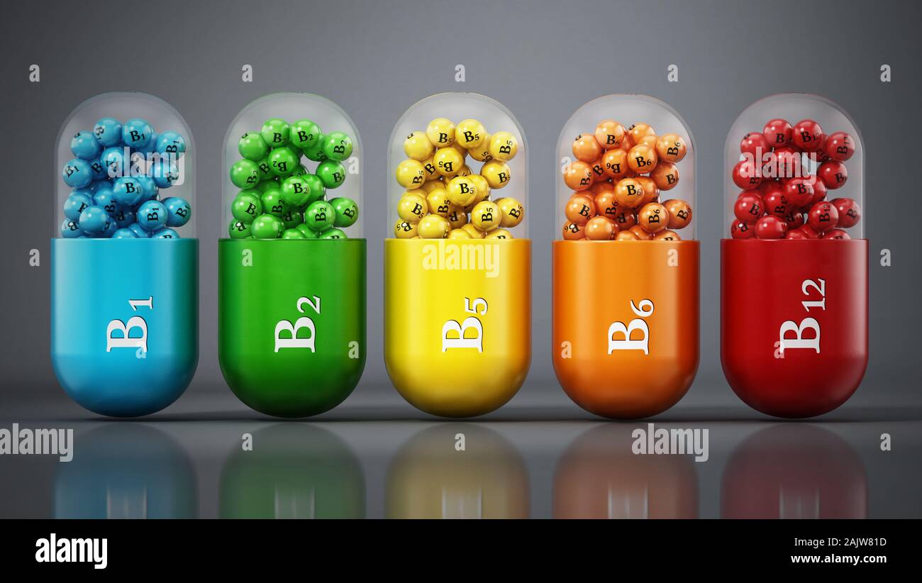 Various vitamin B pills standing on dark gray background. 3D ...