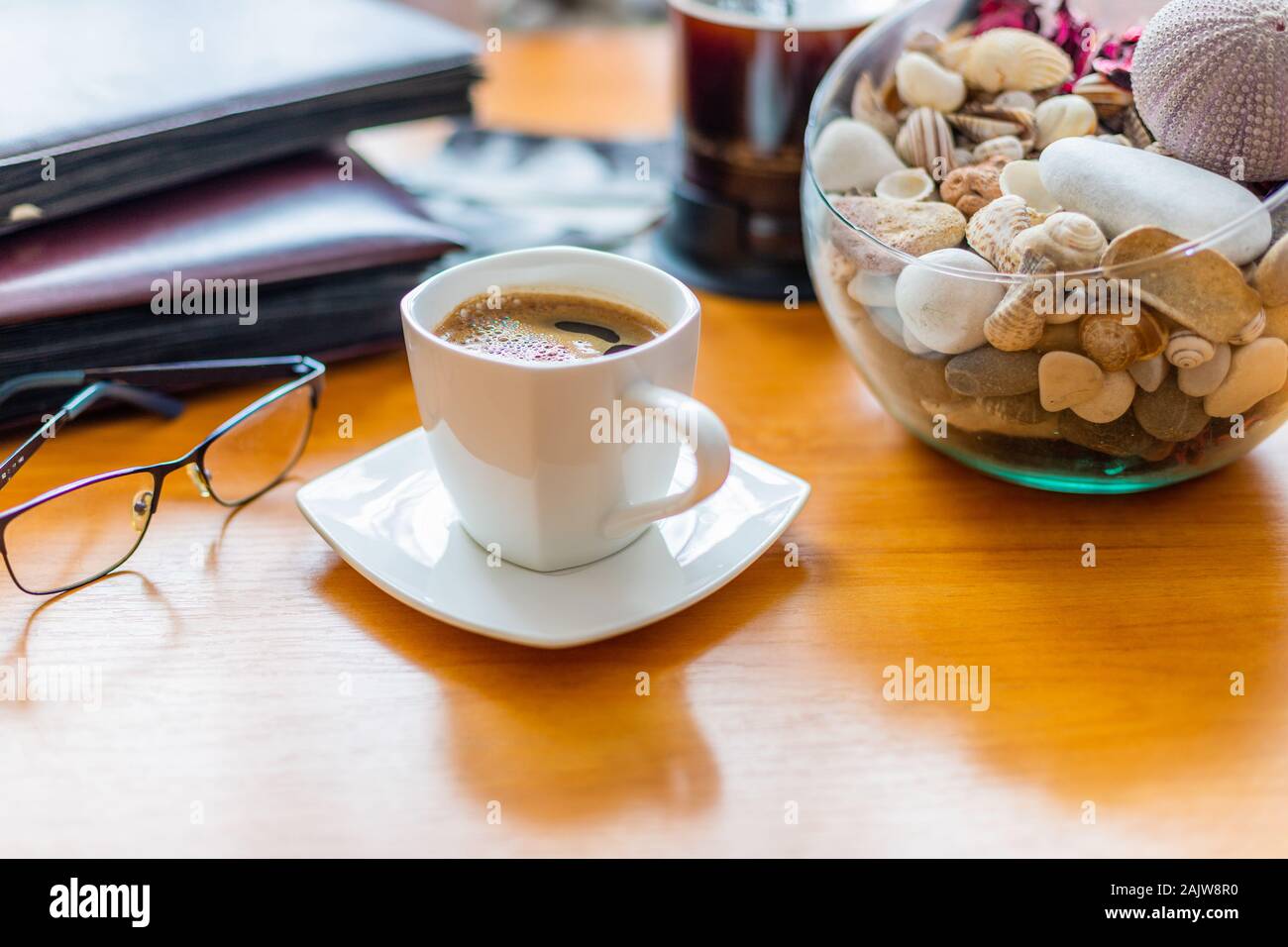 Time for reflection over coffee. White cup. Prescription glasses ...