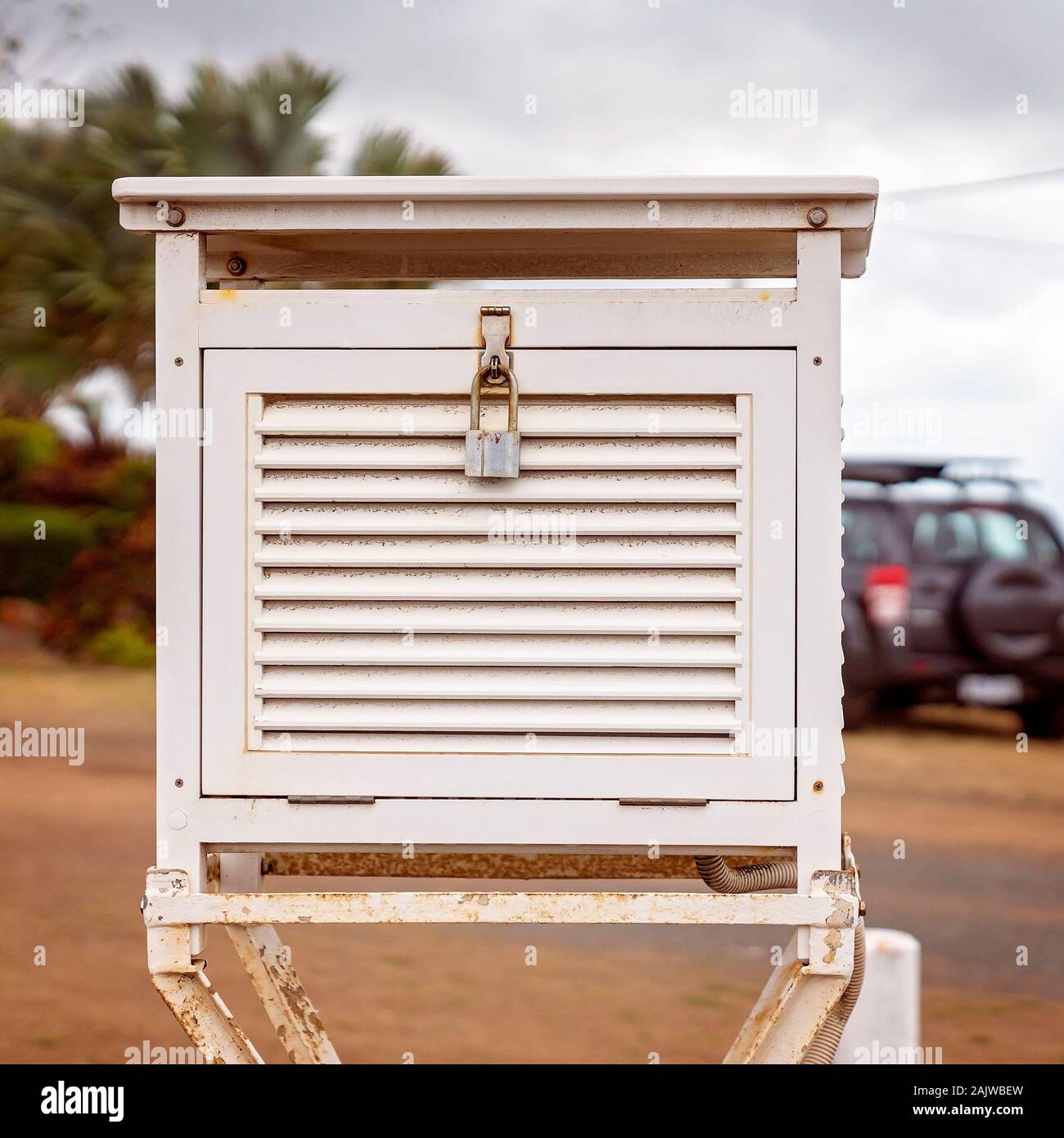 A locked white wooden weather meter box standing in a car park Stock ...