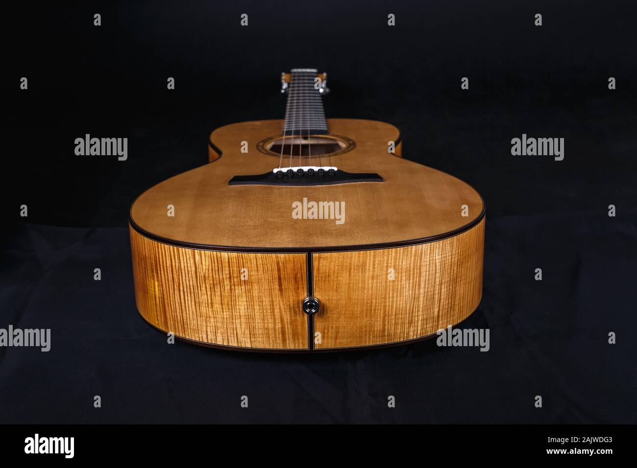 wood texture of lower deck of six strings acoustic guitar on black ...