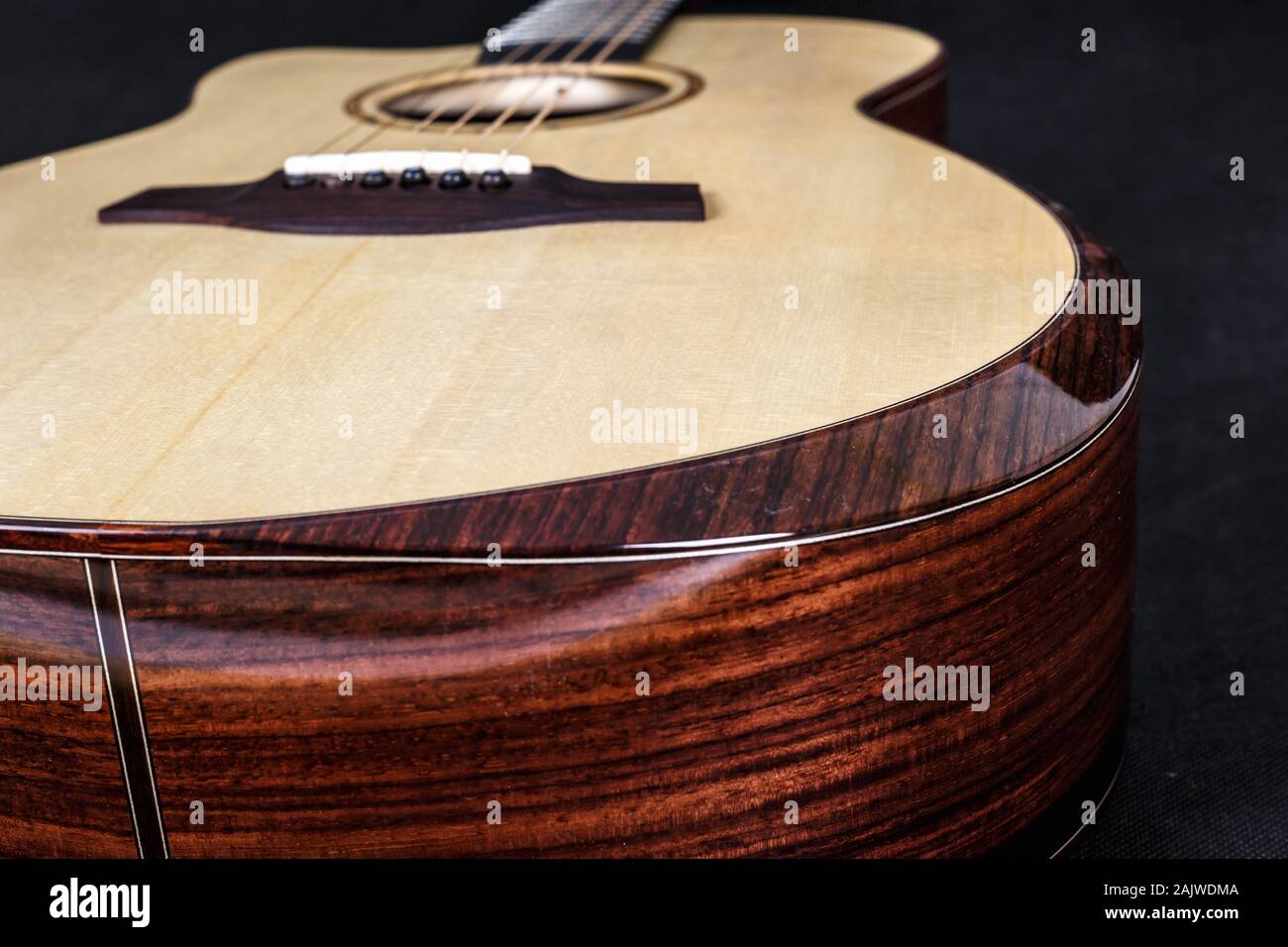 wood texture of lower deck of six strings acoustic guitar on black ...