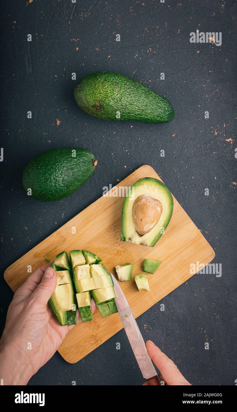 Woman is cleaning avocado for salad Stock Photo - Alamy