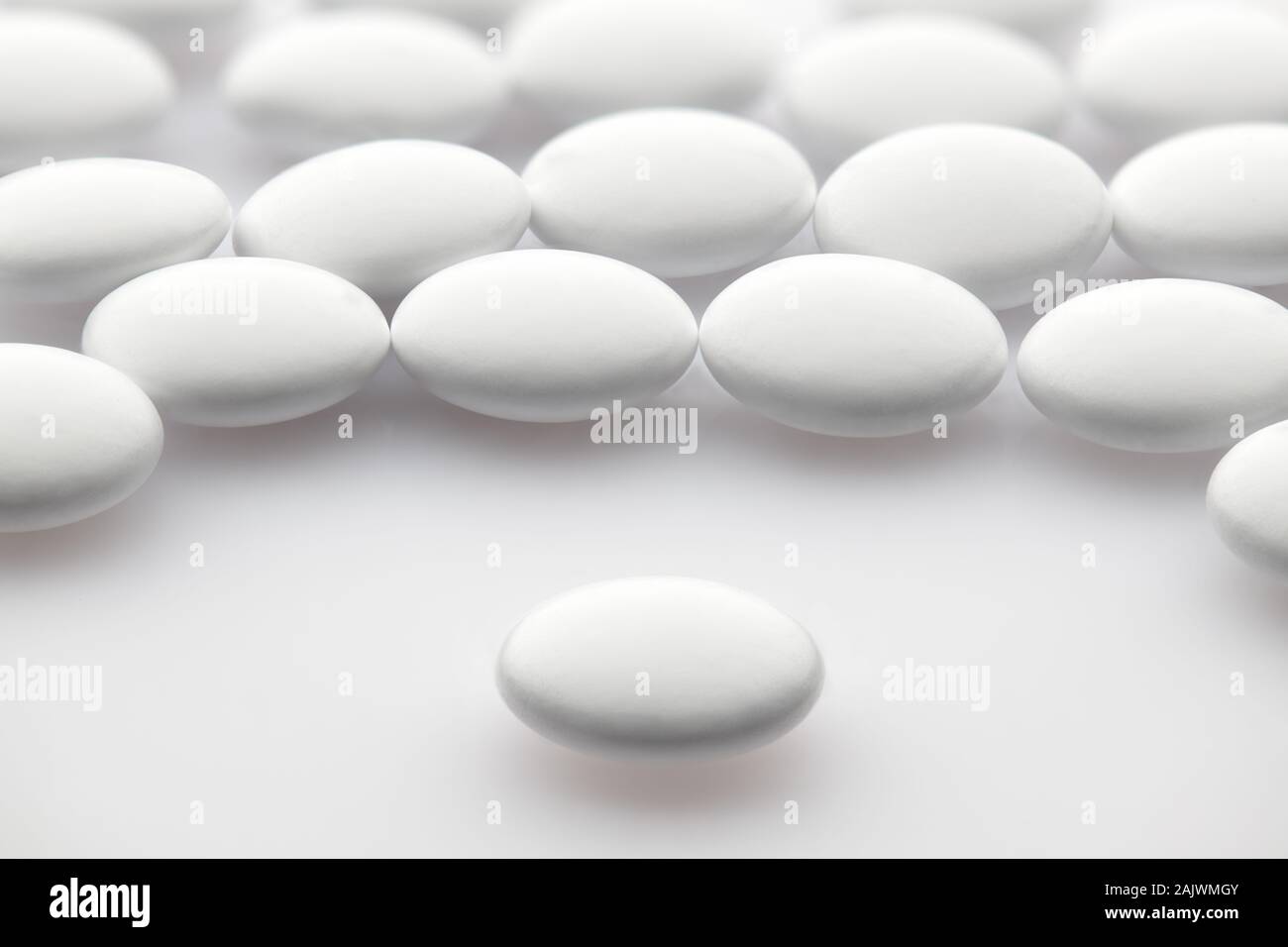 Group of white pills on white background - healthcare and medicament ...