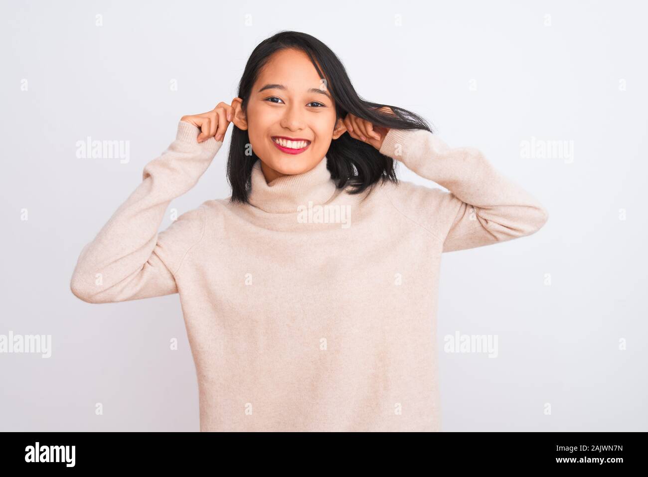 Young chinese woman wearing turtleneck sweater standing over isolated ...