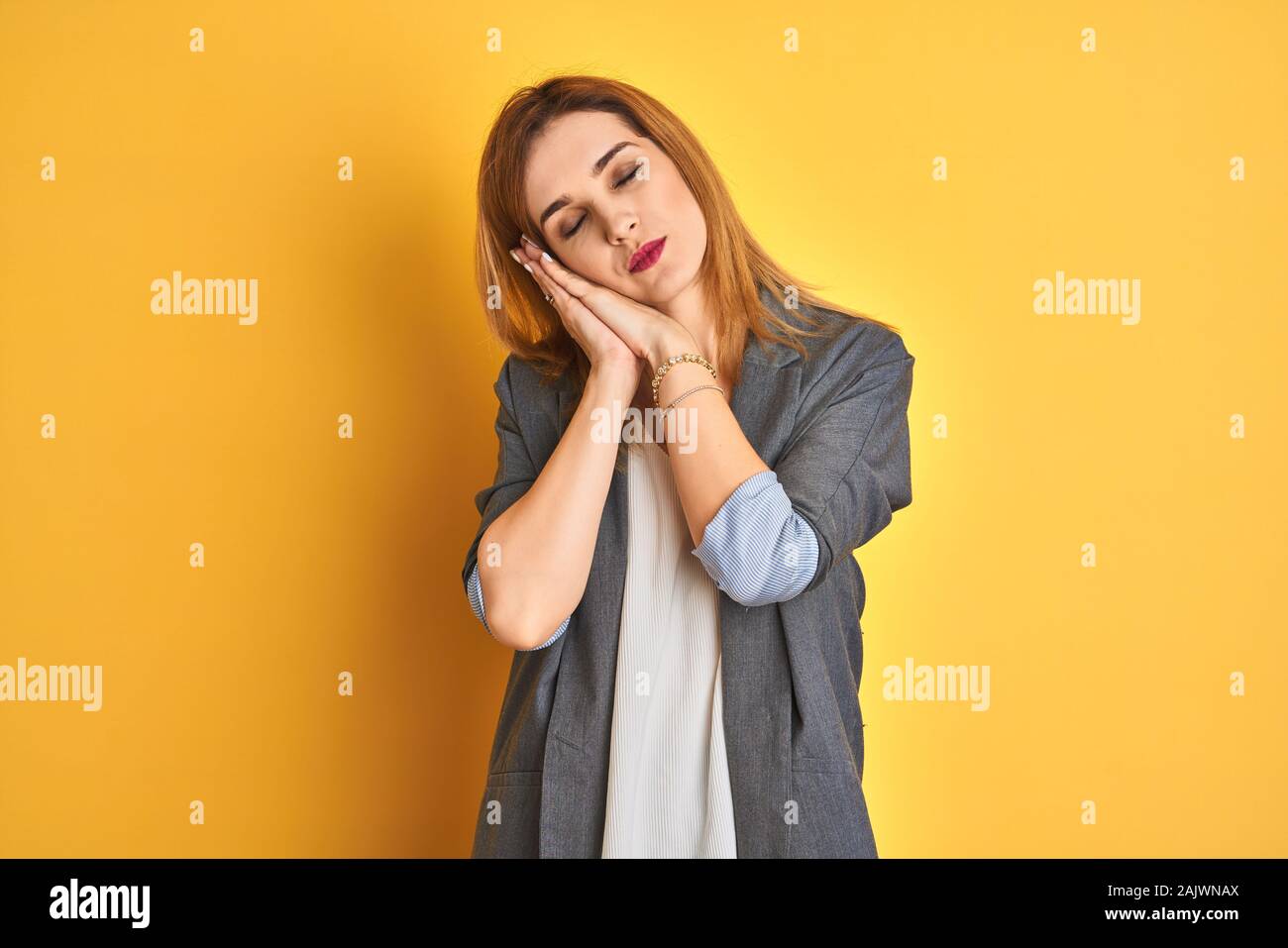 Redhead caucasian business woman over yellow isolated background ...