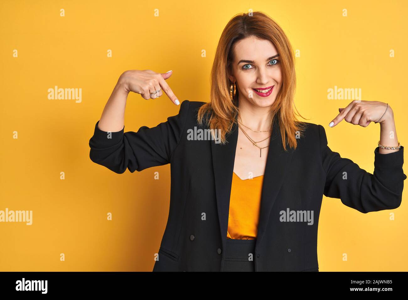Redhead caucasian business woman over yellow isolated background ...