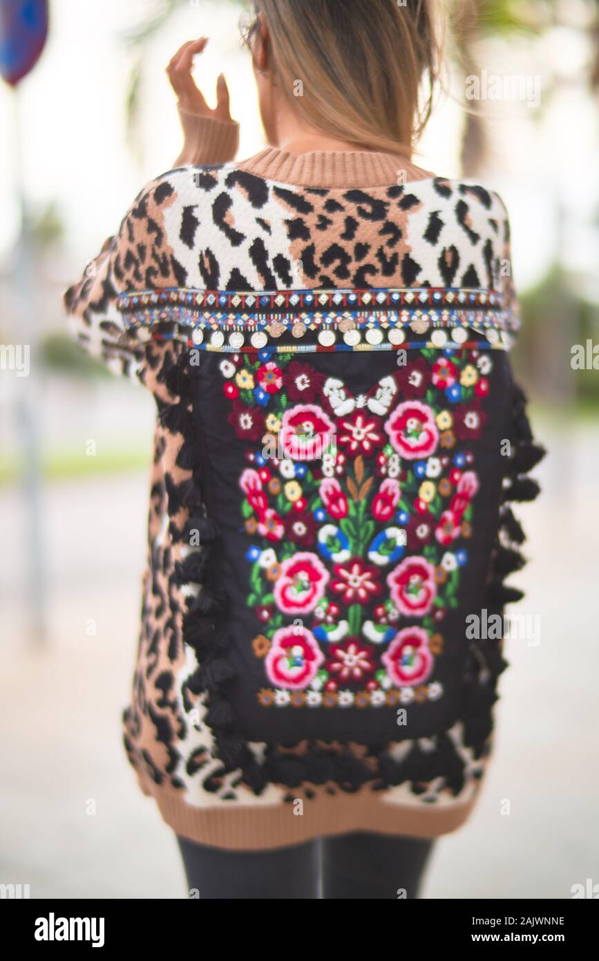 Young beautiful girl wearing animal print cardigan standing backwards ...