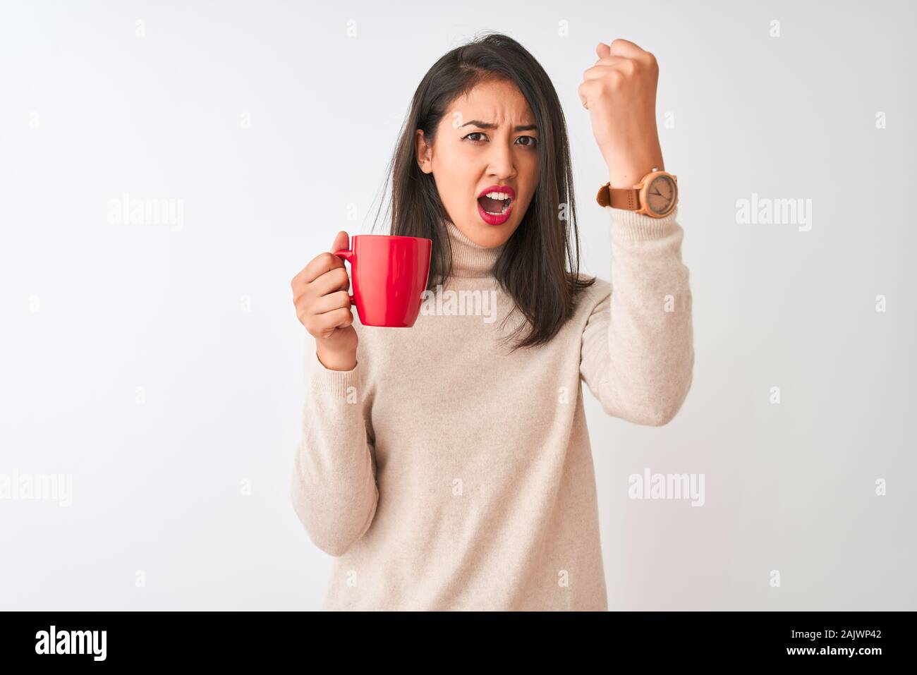 Beautiful chinese woman drinking red cup of coffee standing over ...