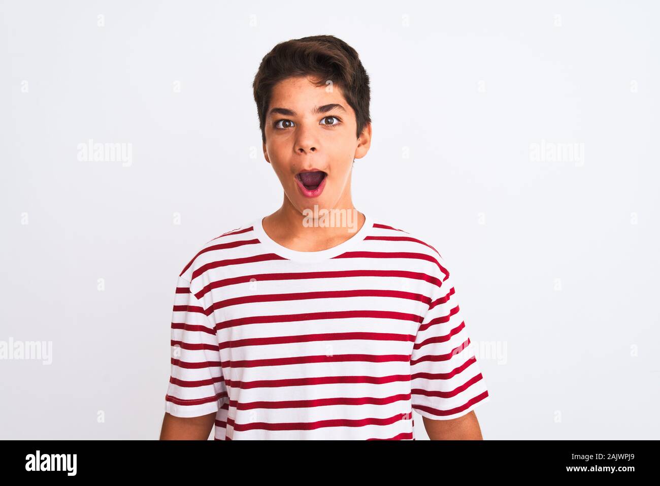 Handsome teenager boy standing over white isolated background afraid ...