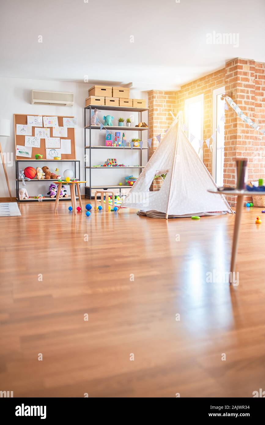 Picture of preschool playroom with colorful furniture, and toys around ...