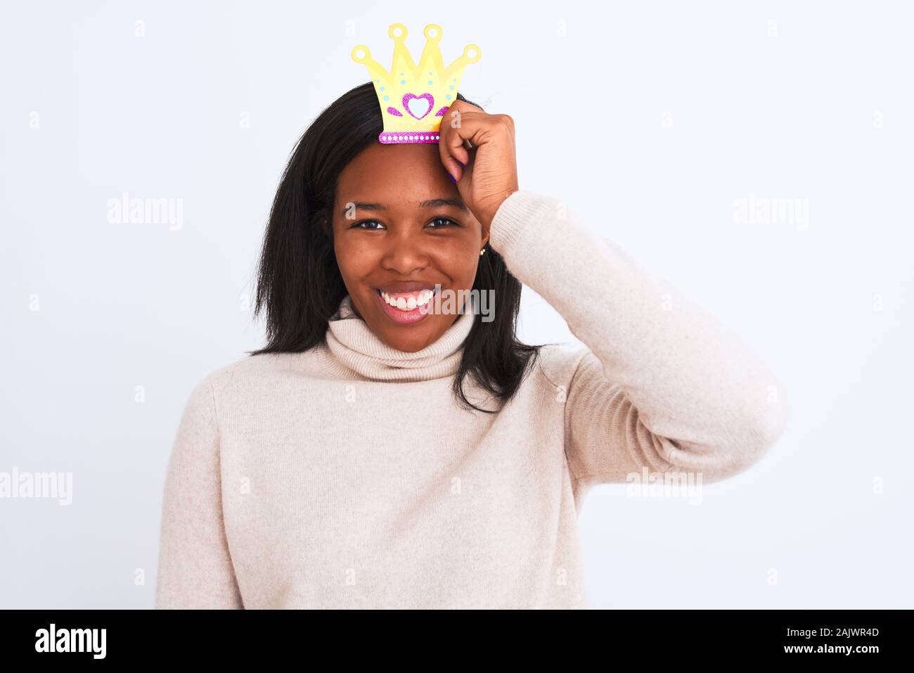 Young african american woman wearing pretend queen crown over isolated ...