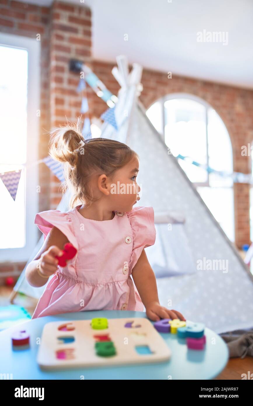 Young beautiful toddler learning mathematics playing with maths game at ...