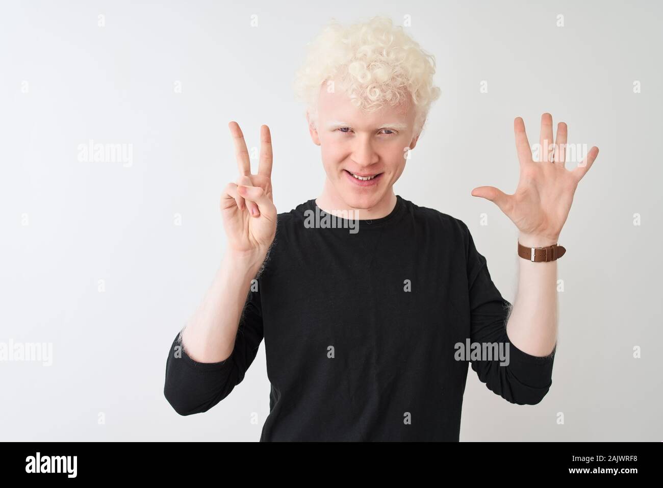 Young albino blond man wearing black t-shirt standing over isolated ...