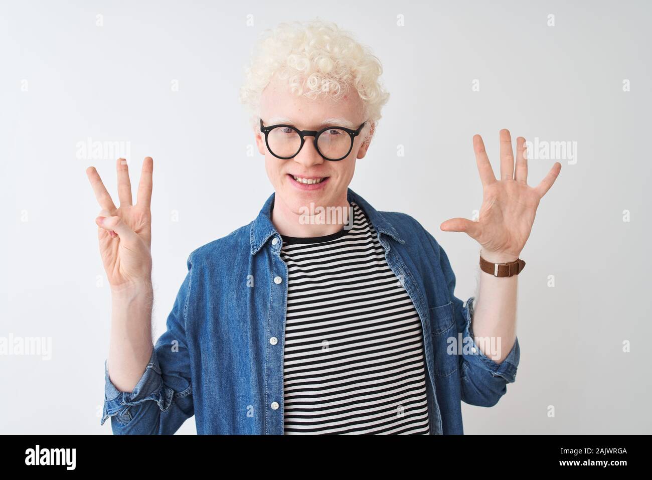 Young albino blond man wearing denim shirt and glasses over isolated ...
