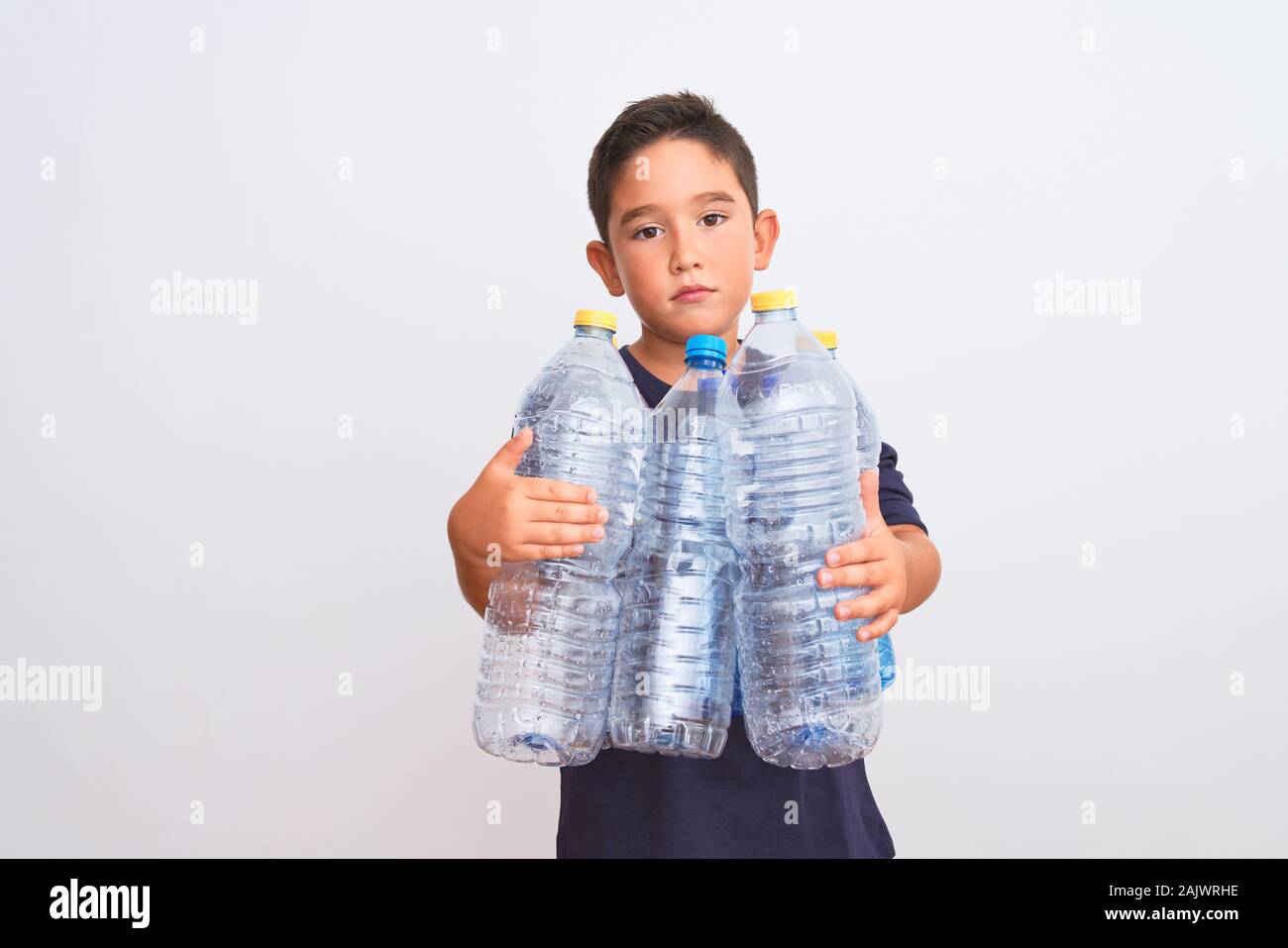 Beautiful kid boy recycling plastic bottles standing over isolated ...