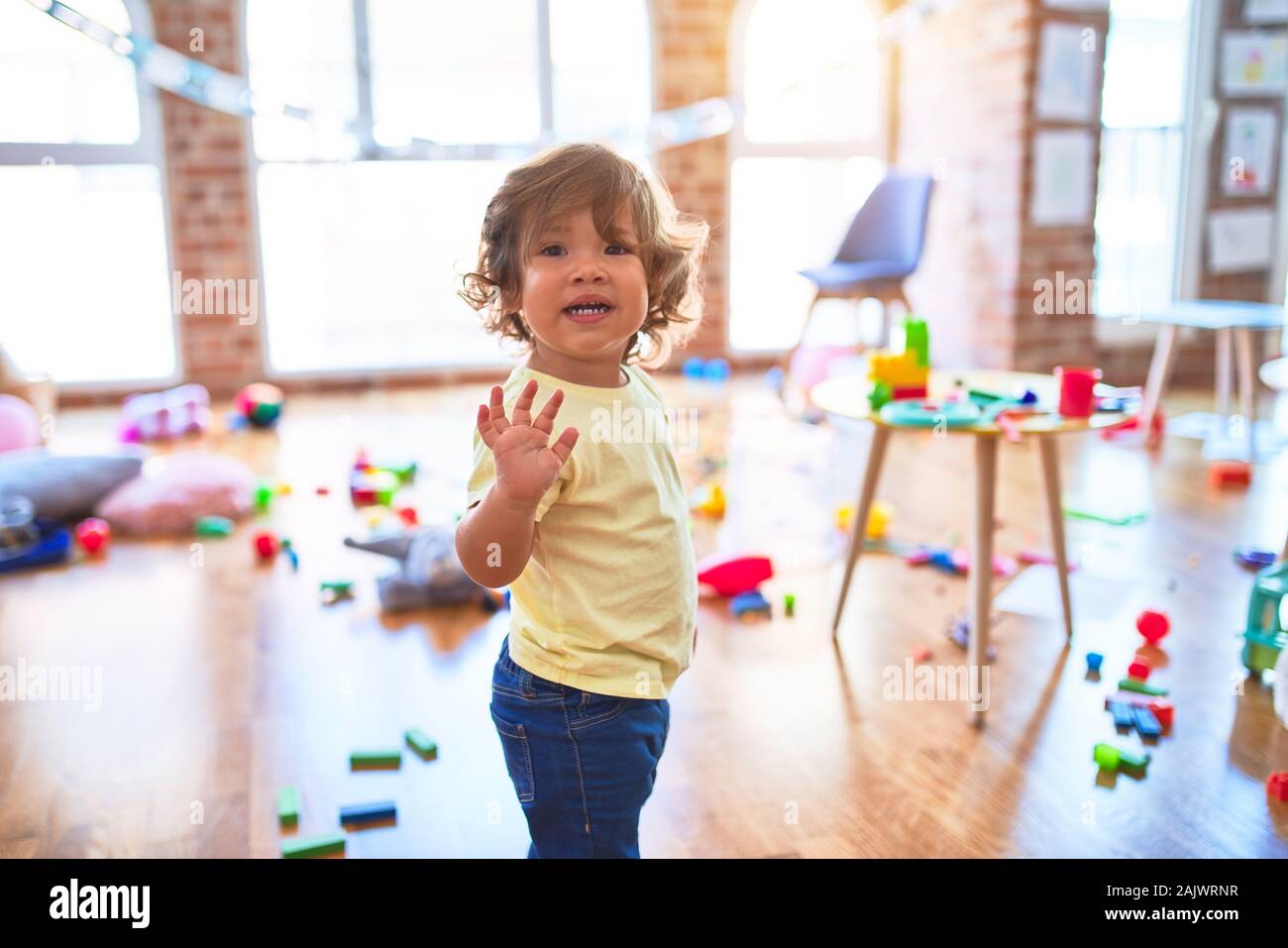 Young beautiful toddler smiling happy. Standing with smile on face at ...