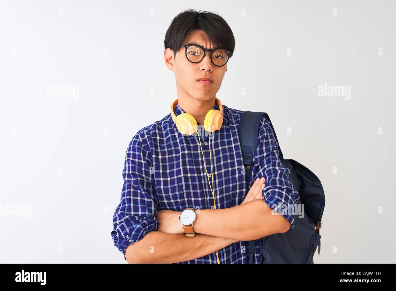 Chinese student man wearing backpack and headphones over isolated white ...