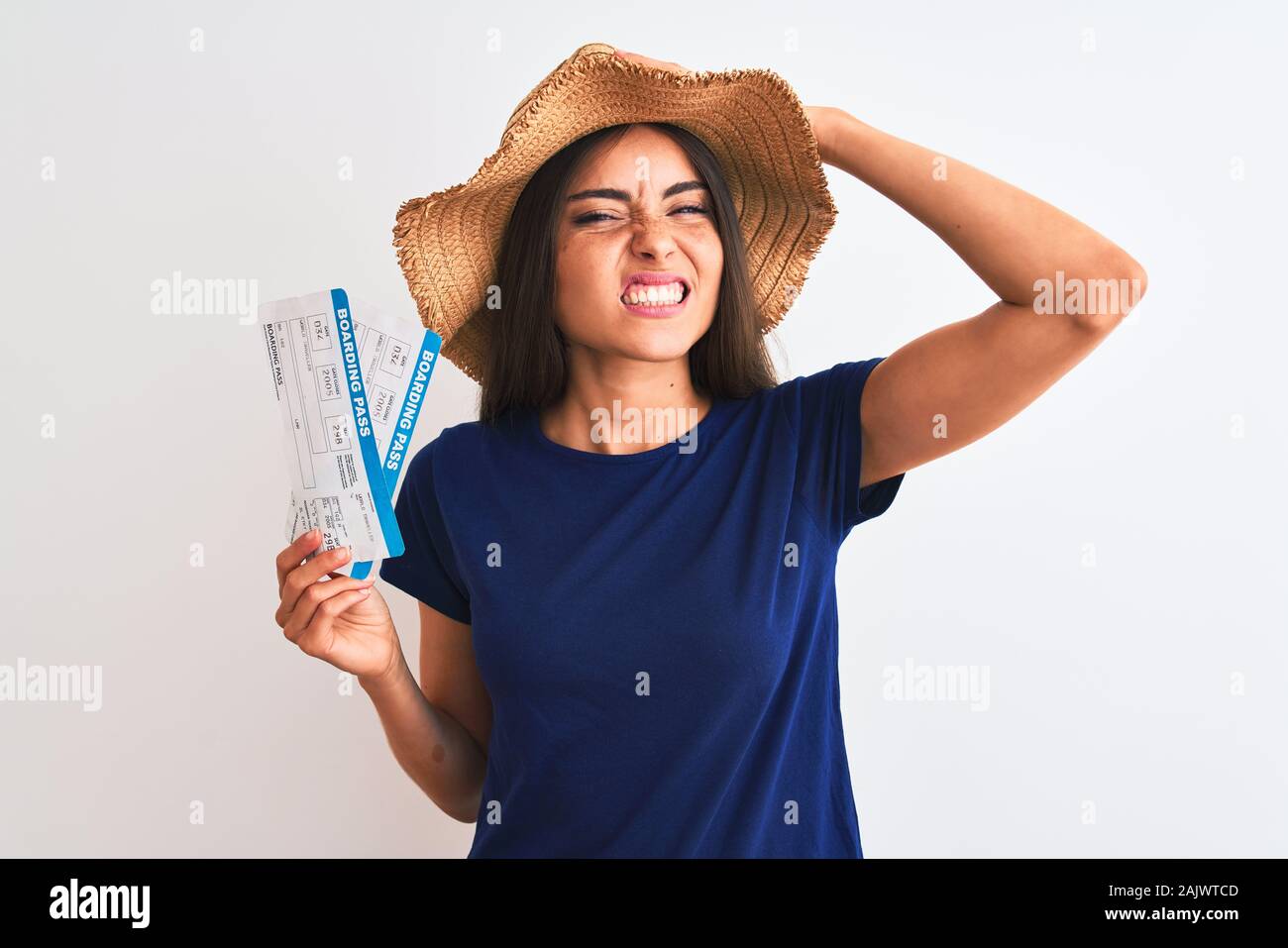 Young beautiful tourist woman holding boarding pass ticket over ...