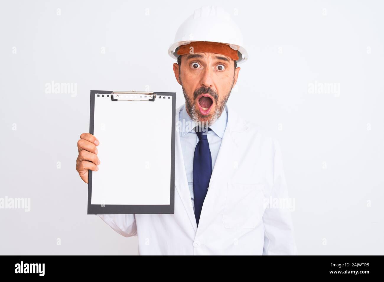 Senior engineer man wearing security helmet holding clipboard over ...