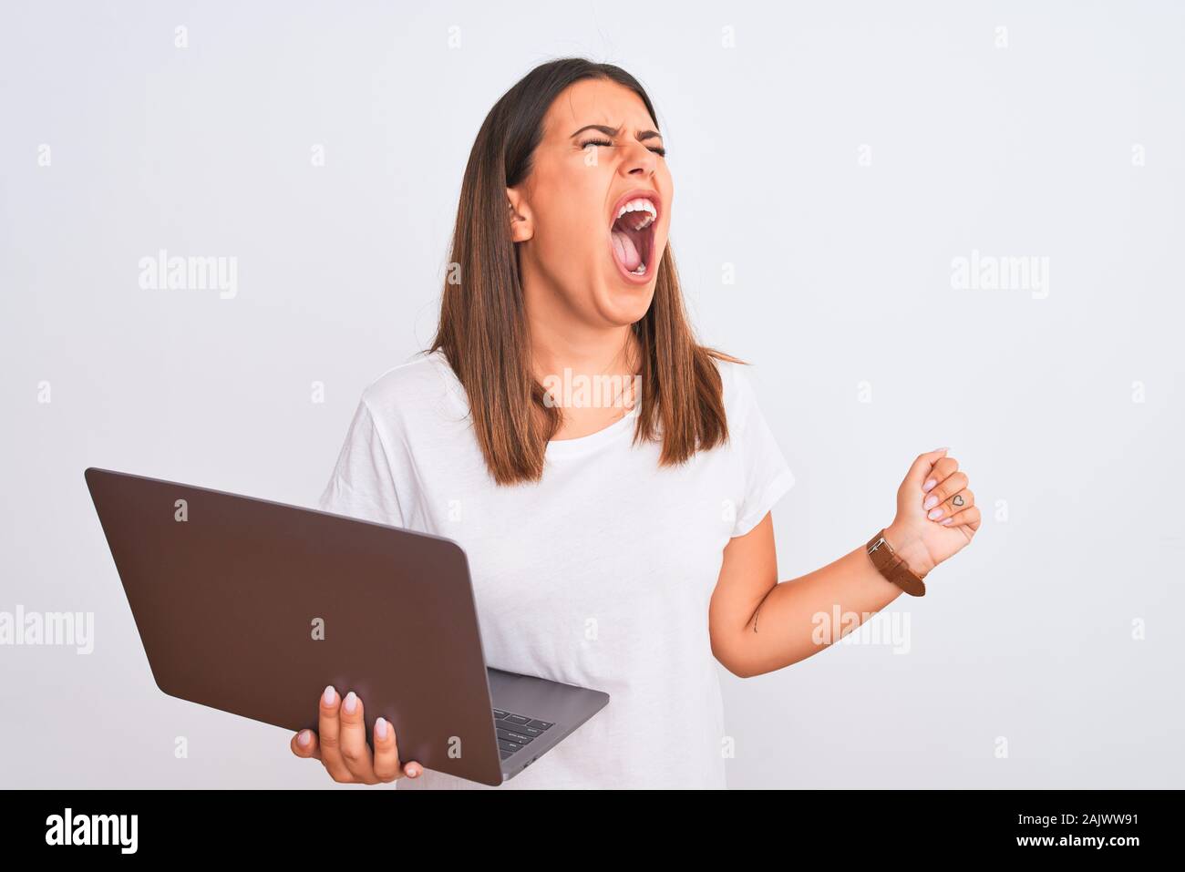 Beautiful young woman working using computer laptop over white ...