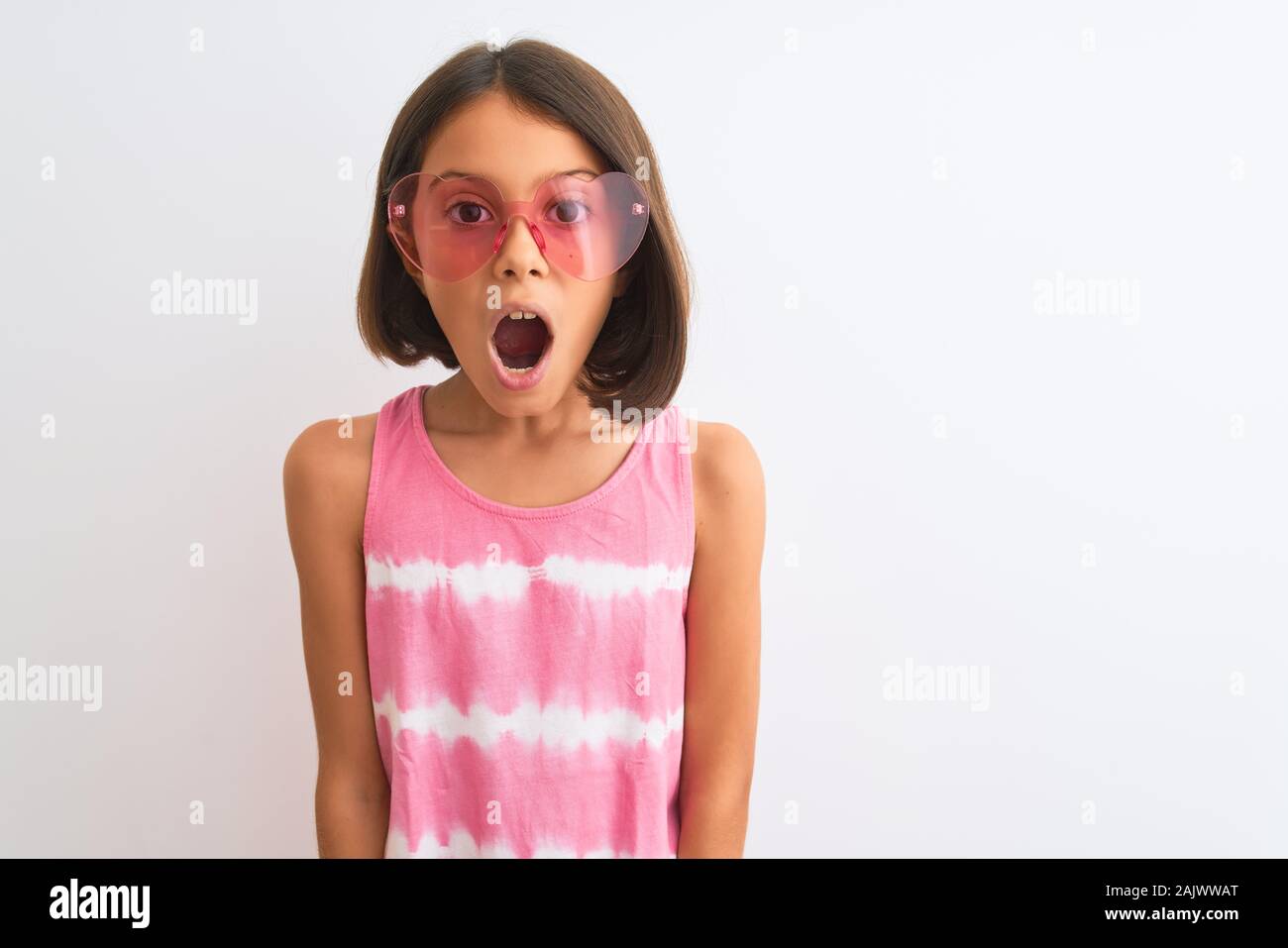 Young beautiful child girl wearing pink t-shirt and sunglasses over ...