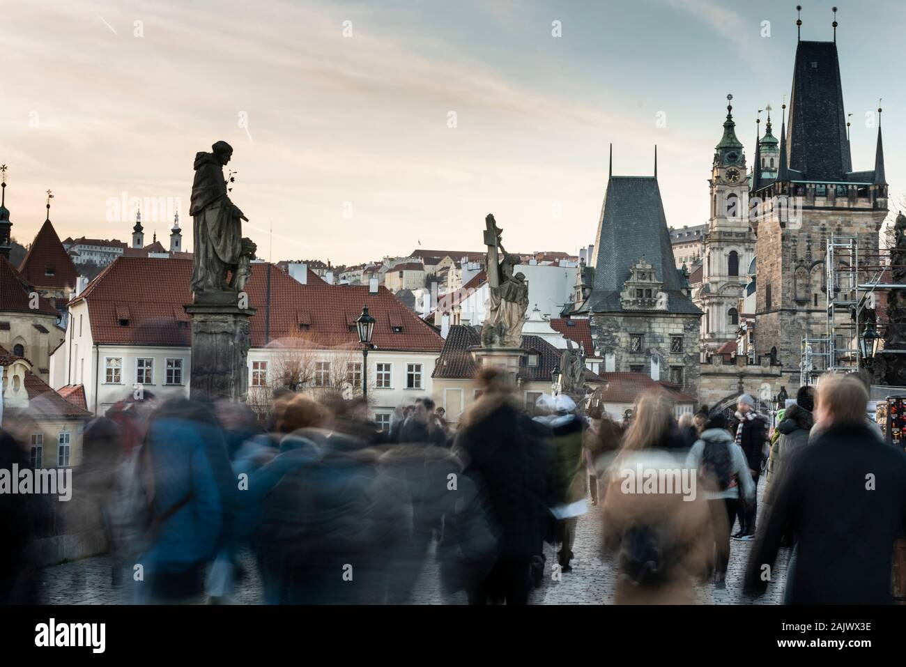Prague Charles Bridge in winter sunny afternoon crowded with tourist ...