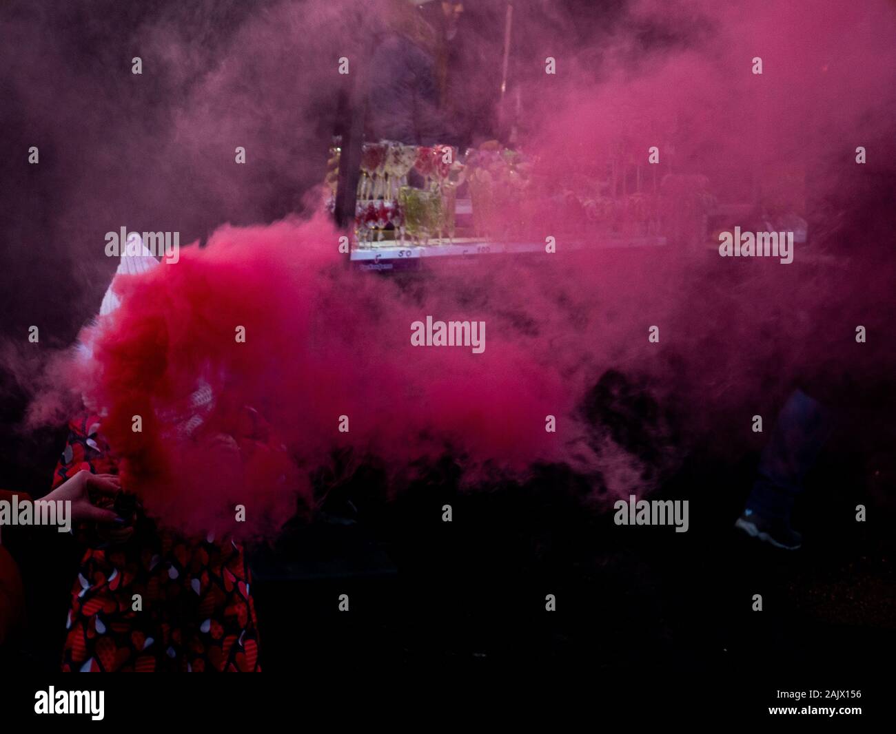 The child uses a smoke bomb. Bright red Stock Photo - Alamy
