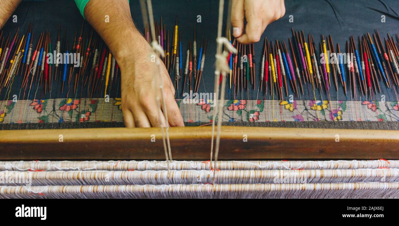 Hand weaving a colorful kashmiri pashmina shawl with light source ...