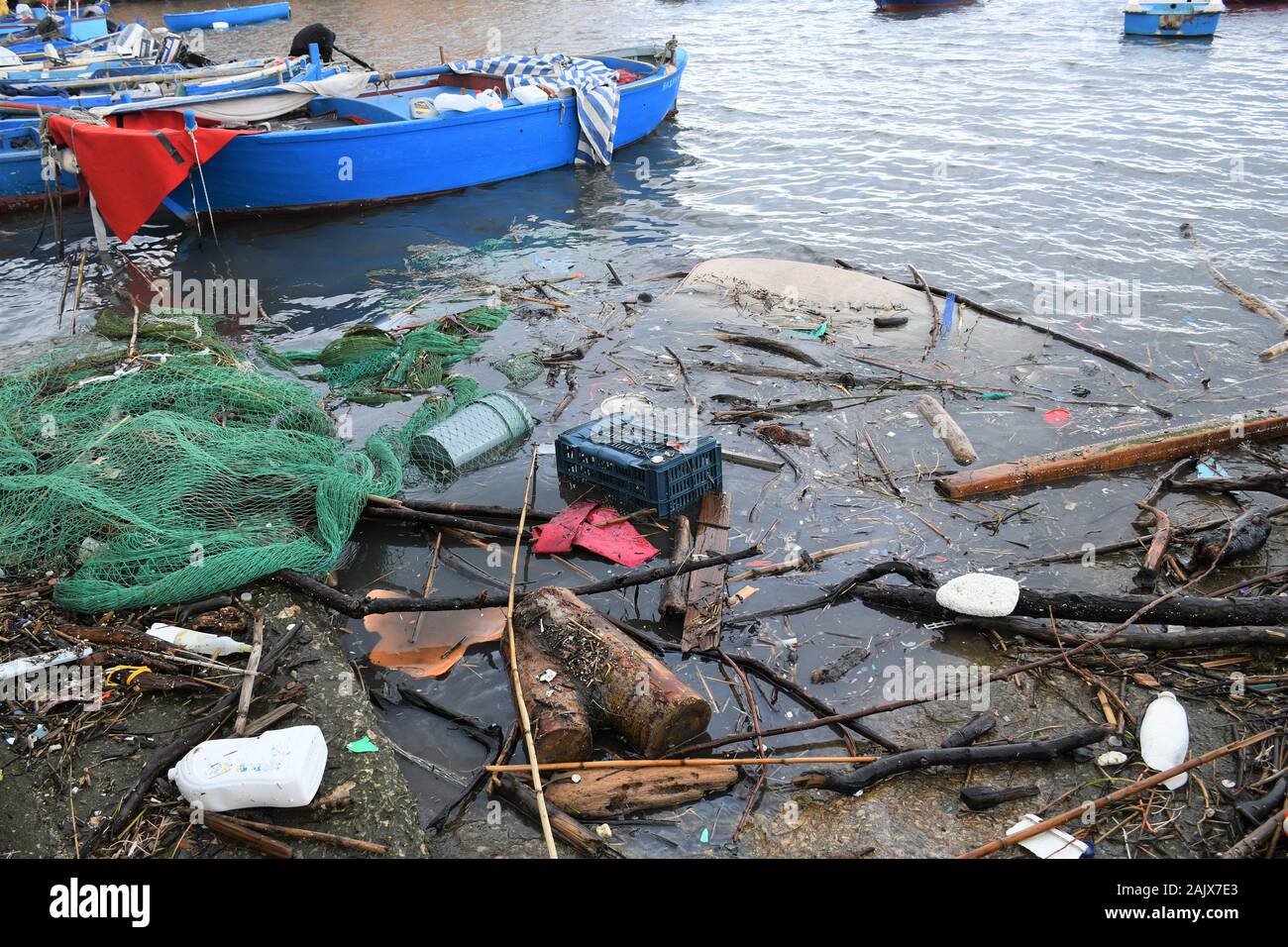 Plastic and microplastic waste and garbage floating in the water with ...