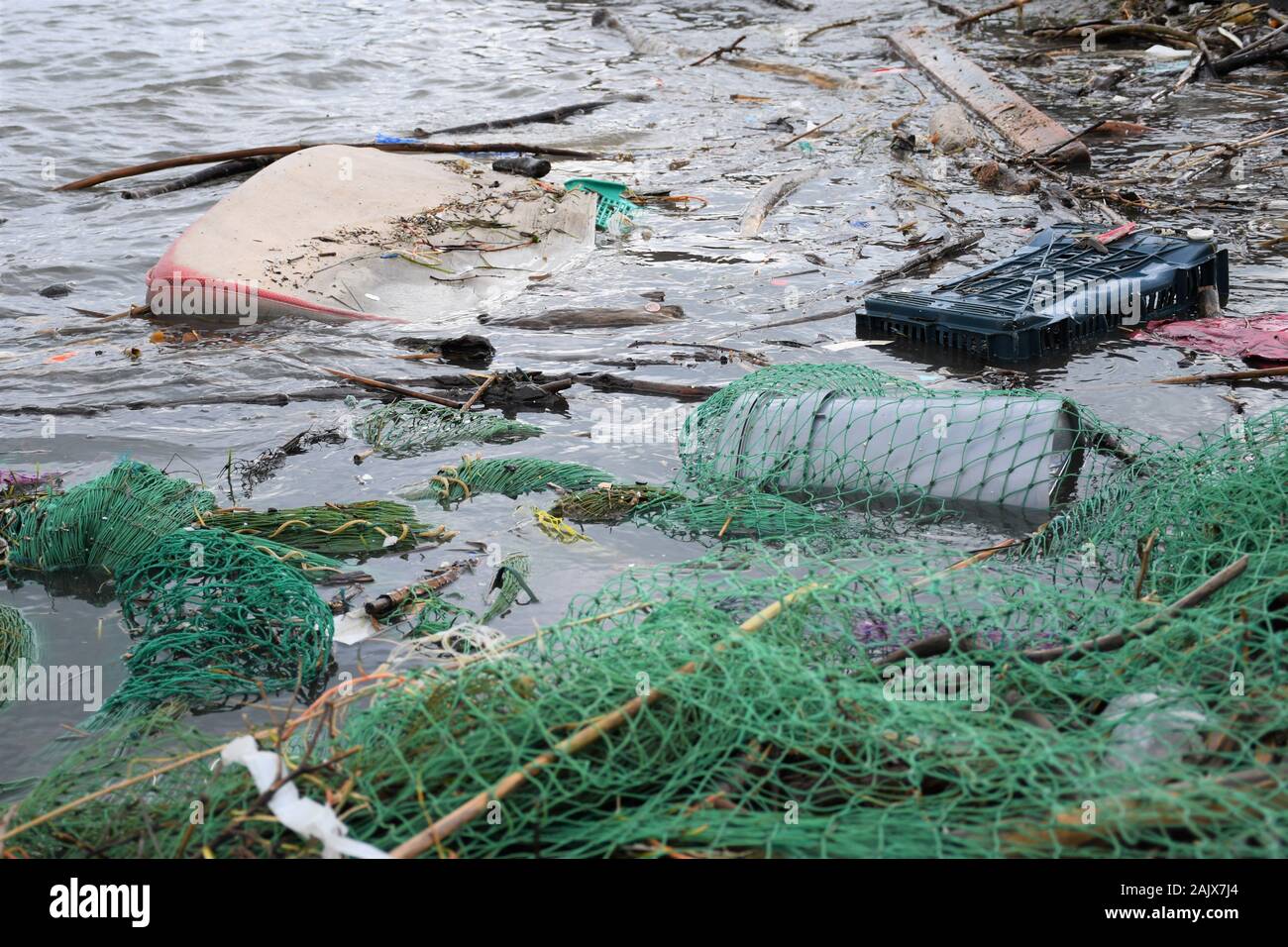 Plastic and microplastic waste and garbage floating in the water with ...