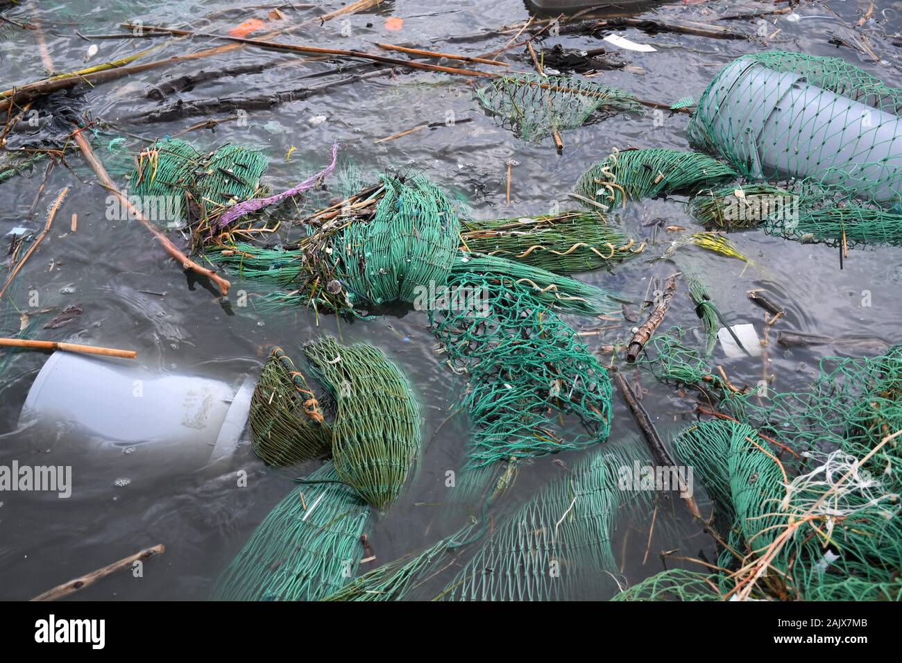 Plastic and microplastic waste and garbage floating in the water with ...