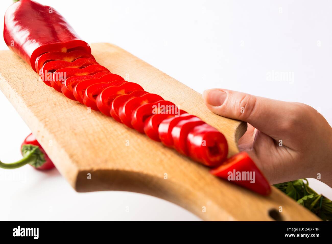 cutted red capa pepper hand holding on kitchen board Stock Photo - Alamy