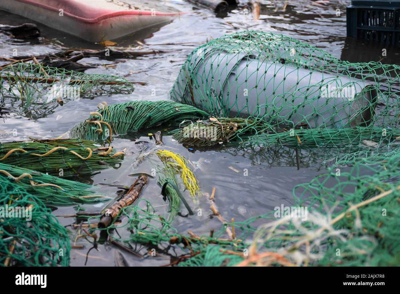 Plastic and microplastic waste and garbage floating in the water with ...