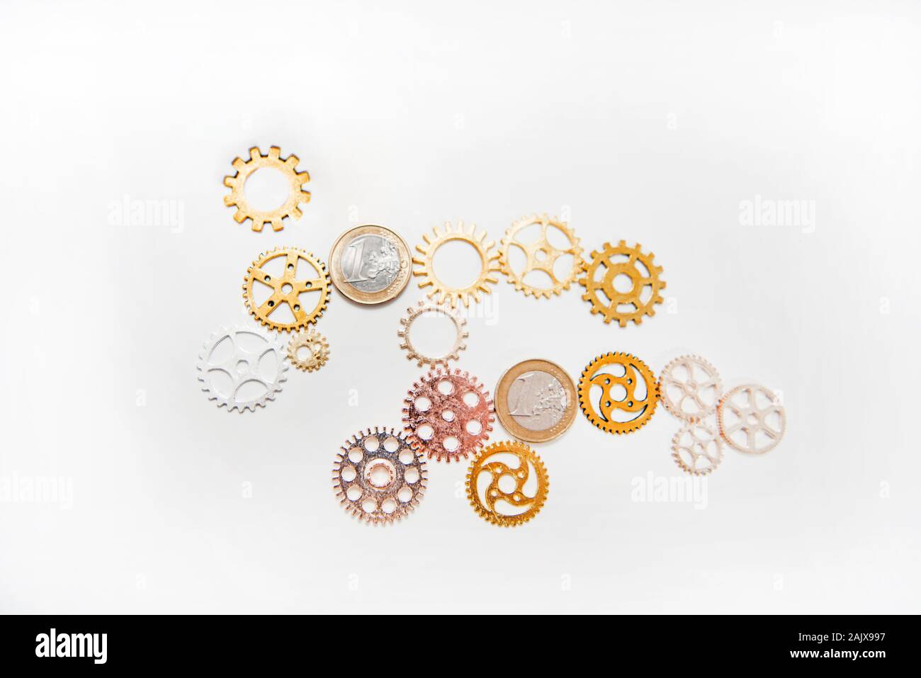 Clock gear wheels on white table with euro coins. Money currency ...