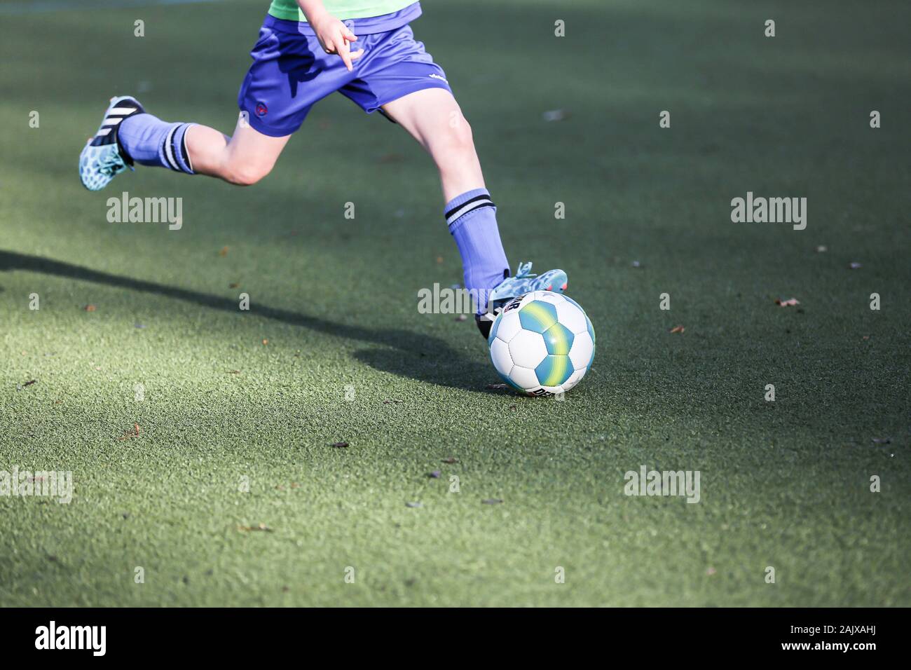 young football player running with the ball Stock Photo - Alamy