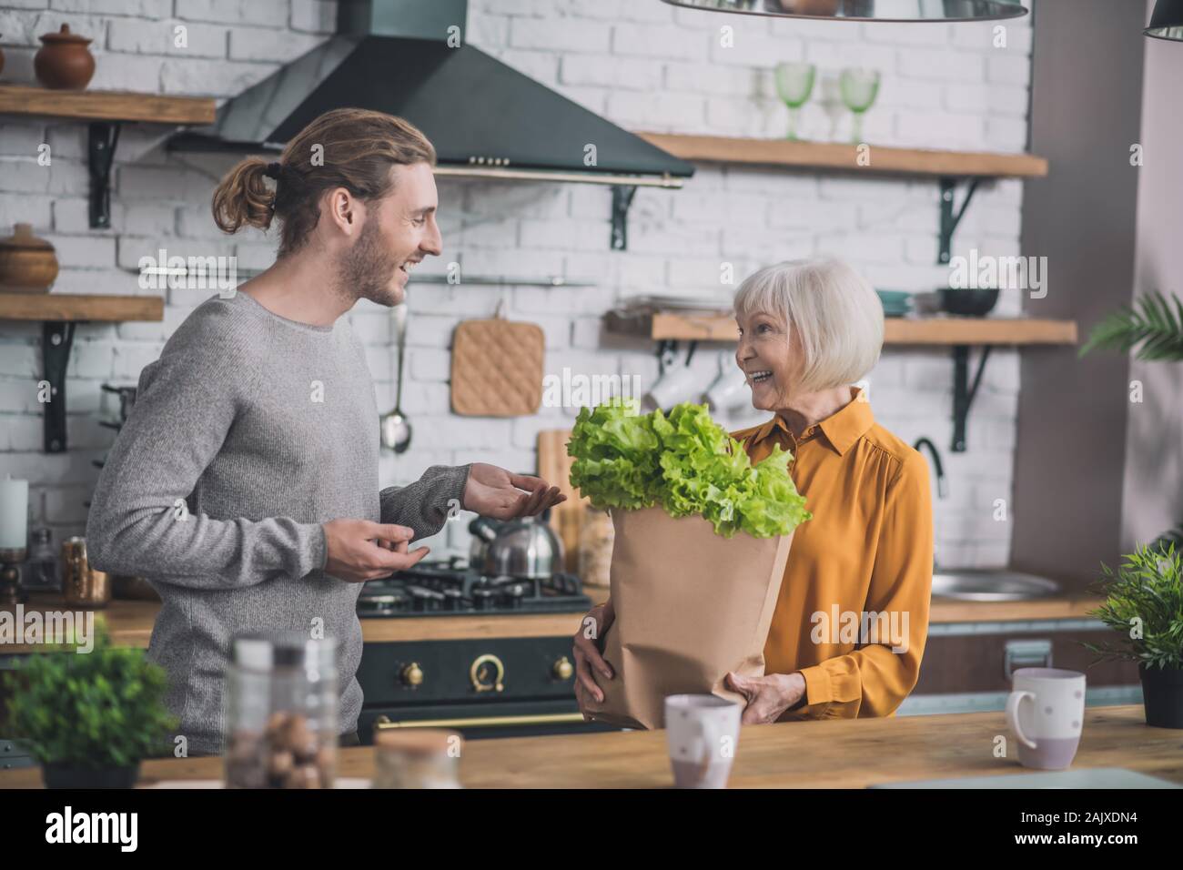 Young smiling man and his mom smiling to each other Stock Photo - Alamy