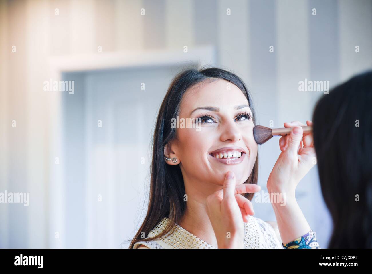 Make up session with a female beauty entrepreneur performing a precise ...