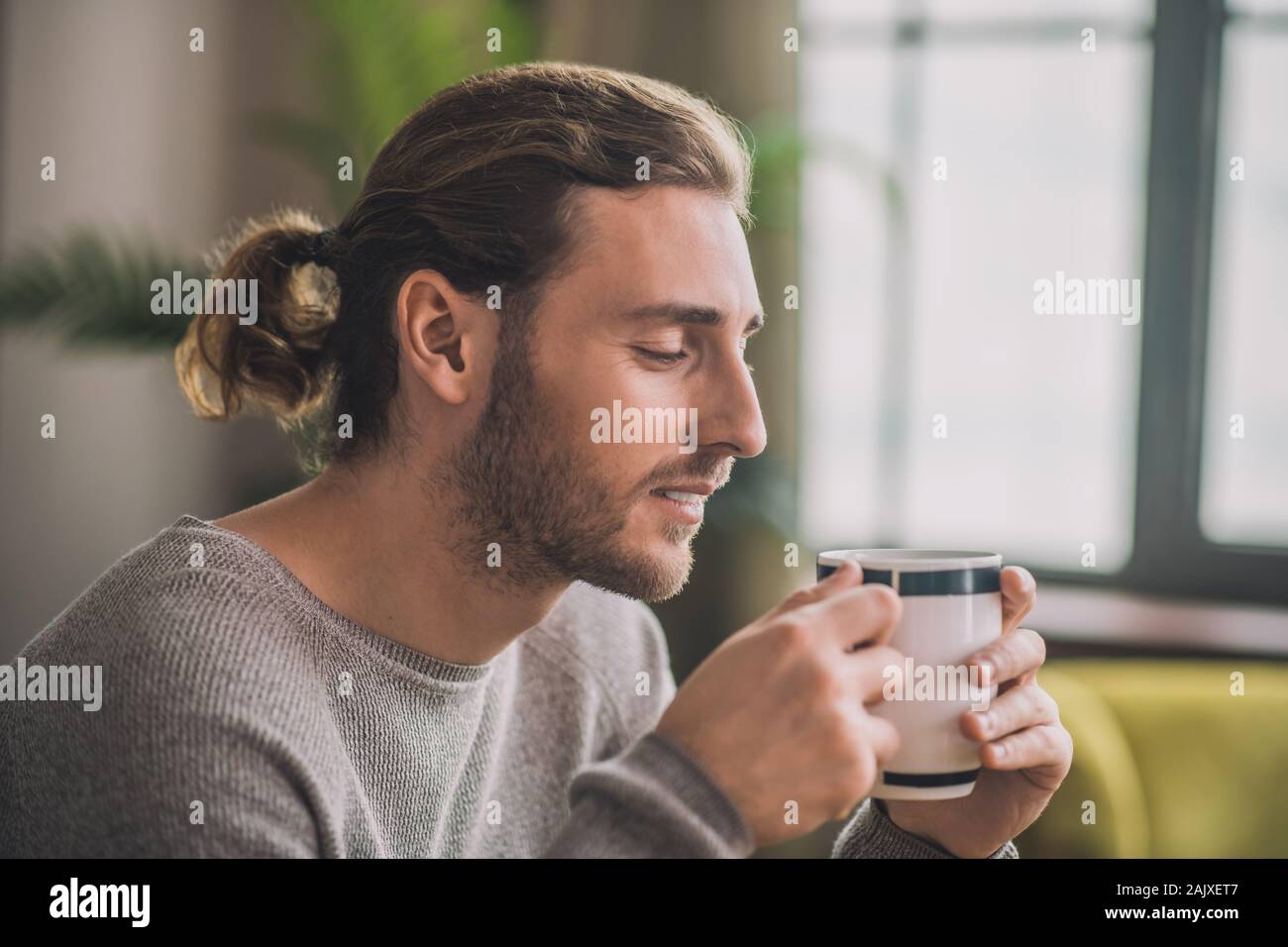 Young man having coffee home hi-res stock photography and images - Alamy