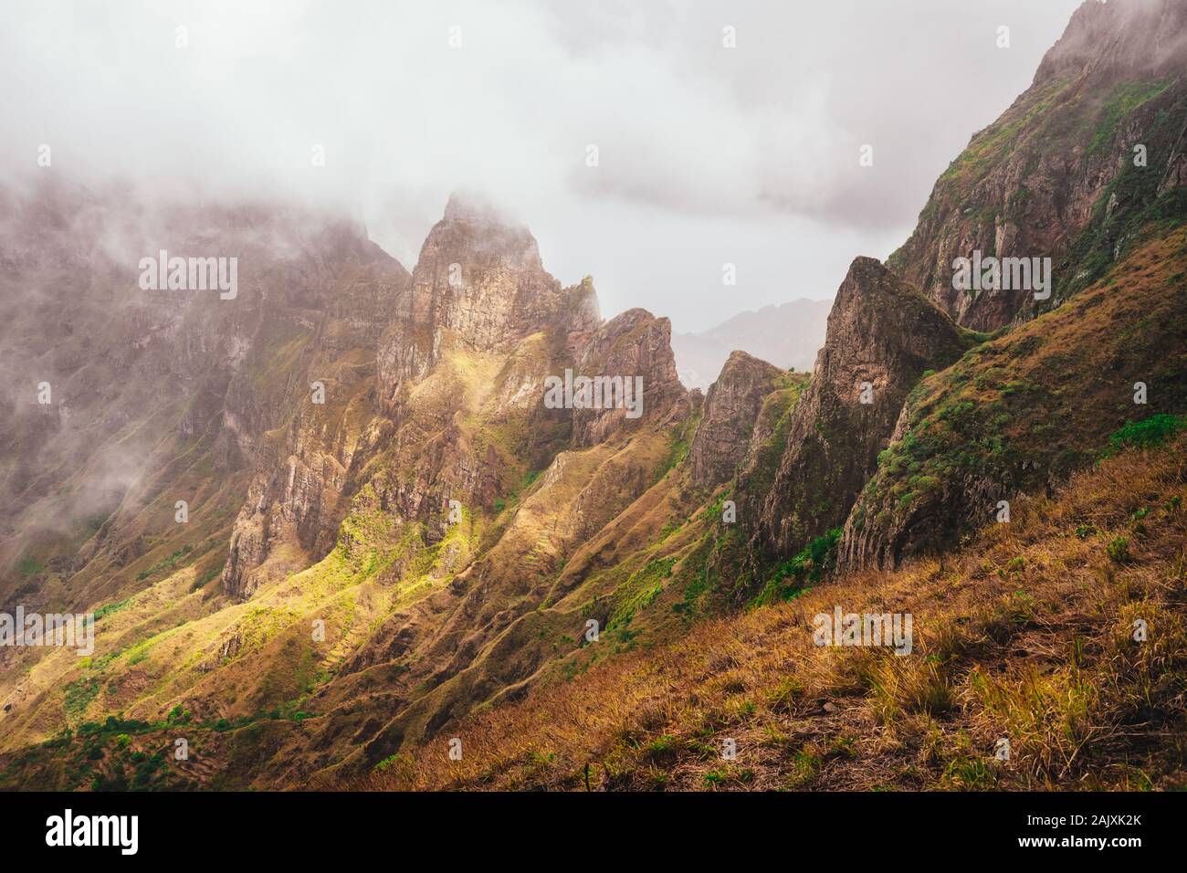 Santo Antao, Cape Verde. Mountain tops covered in fog and lit by the ...