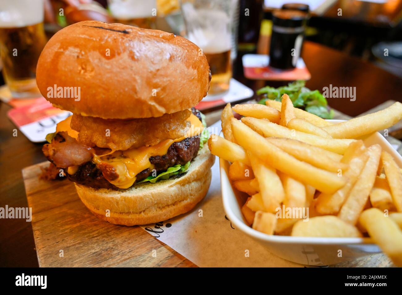 Cheeseburger with a tray of chips Stock Photo - Alamy