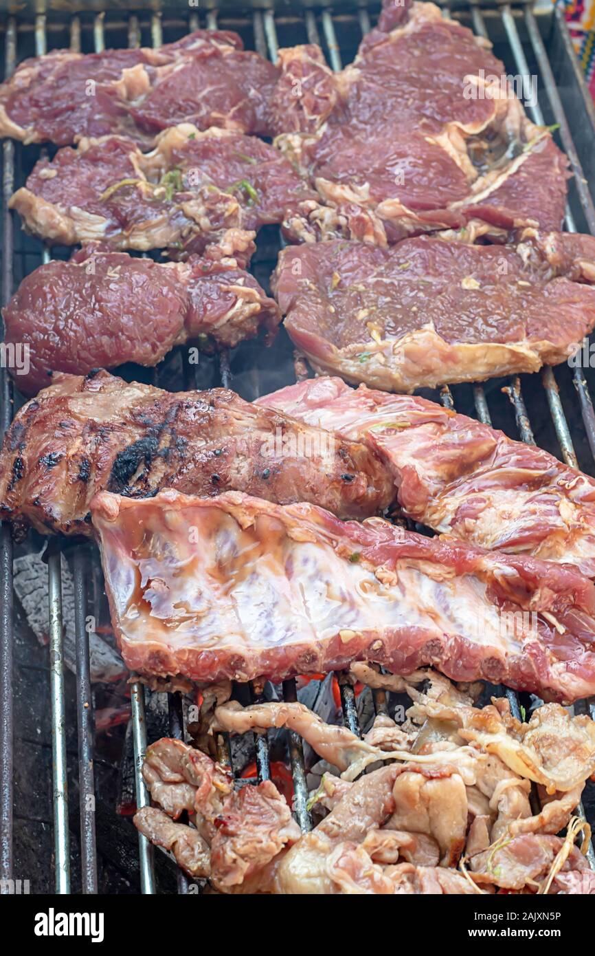 Pork and beef roast on the grill made of stainless tanks in park Stock ...