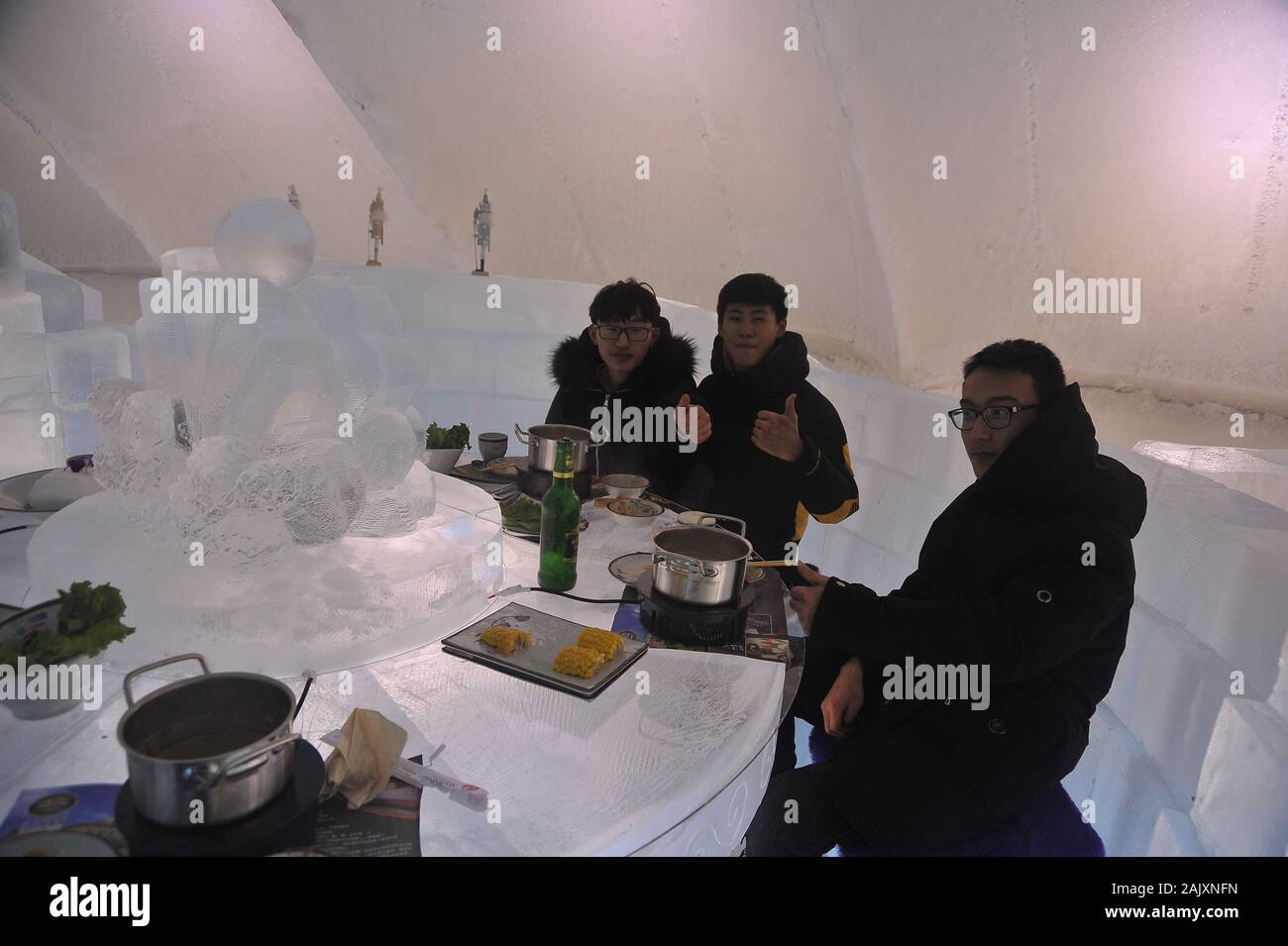 Chinese tourists enjoy hotpots in an ice house during the Harbin Ice ...