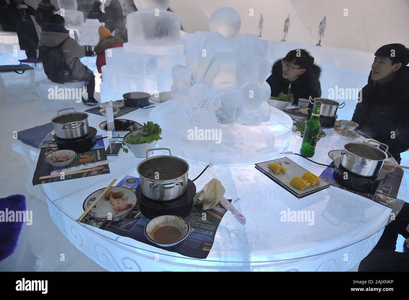 Chinese tourists enjoy hotpots in an ice house during the Harbin Ice ...