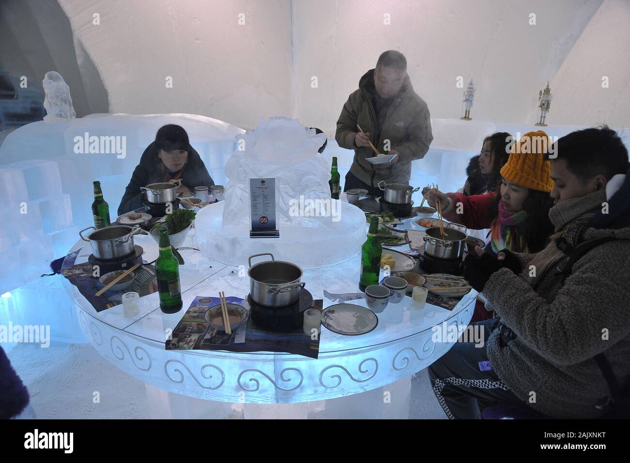 Chinese tourists enjoy hotpots in an ice house during the Harbin Ice ...