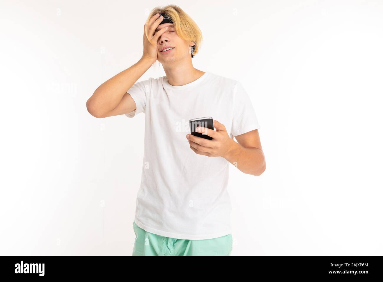 Caucasian charming handsome man forgot something and holds his head in ...