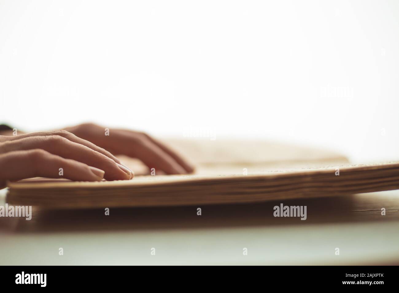 Woman's hands are reading a book Stock Photo - Alamy
