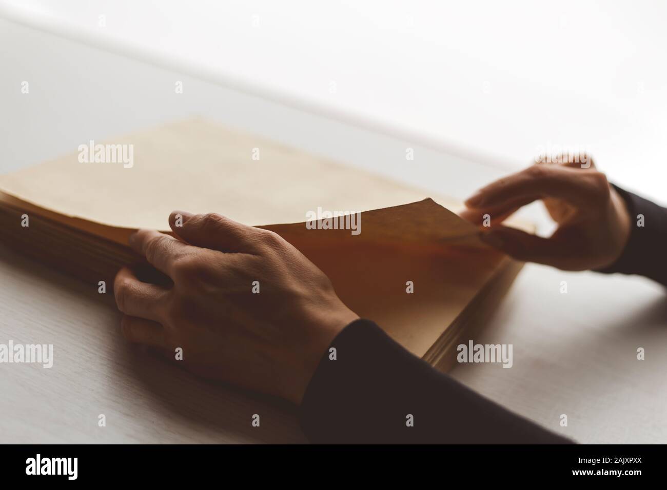 Woman's hands are reading a book Stock Photo - Alamy